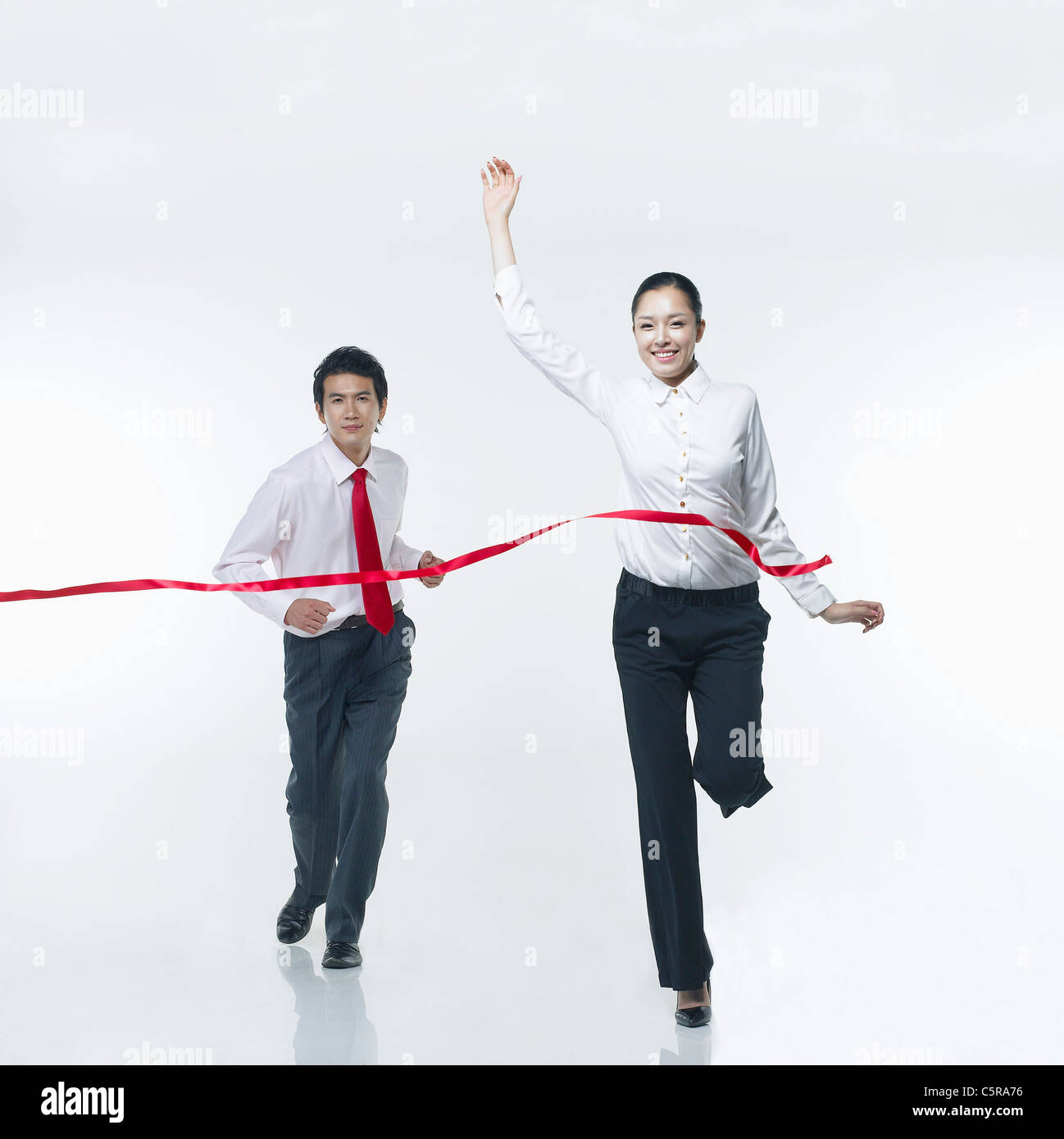 A business woman breaking the finishing tape in a race Stock Photo - Alamy