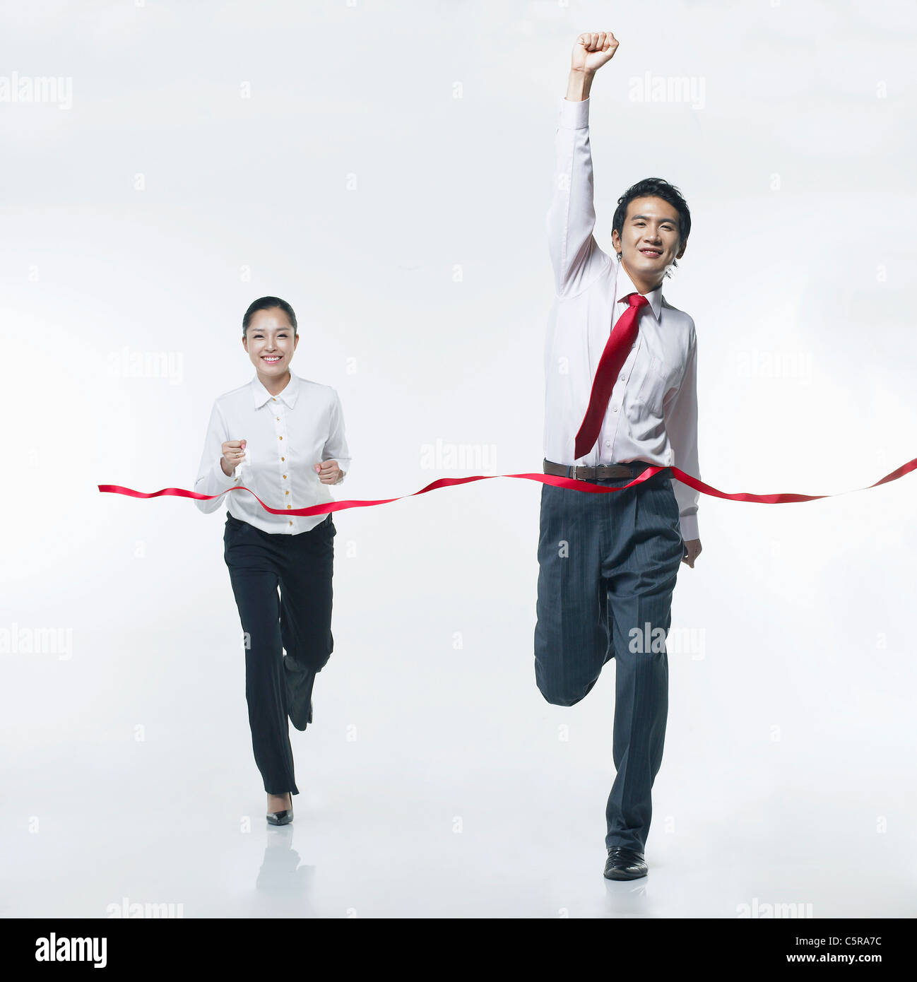 A business man breaking the finishing tape in a race Stock Photo - Alamy