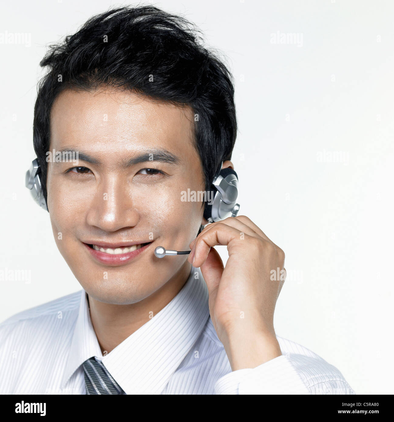 A man wearing headset smiling Stock Photo - Alamy