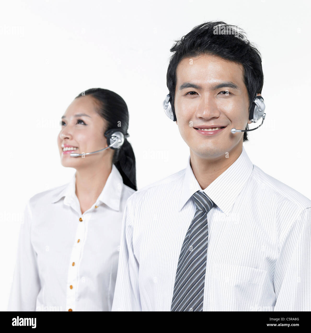 A man and a woman wearing headsets Stock Photo - Alamy
