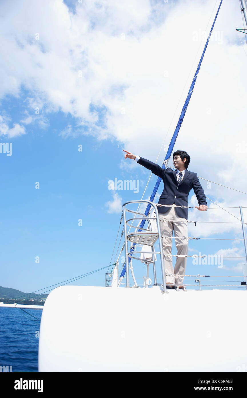 A man standing on a boat pointing somewhere Stock Photo - Alamy