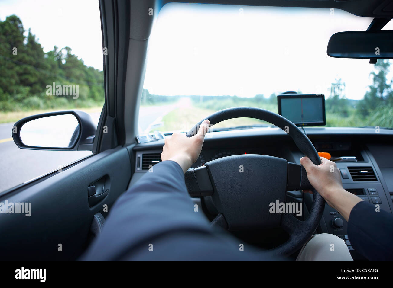 Hands of a man on a steering wheel Stock Photo - Alamy