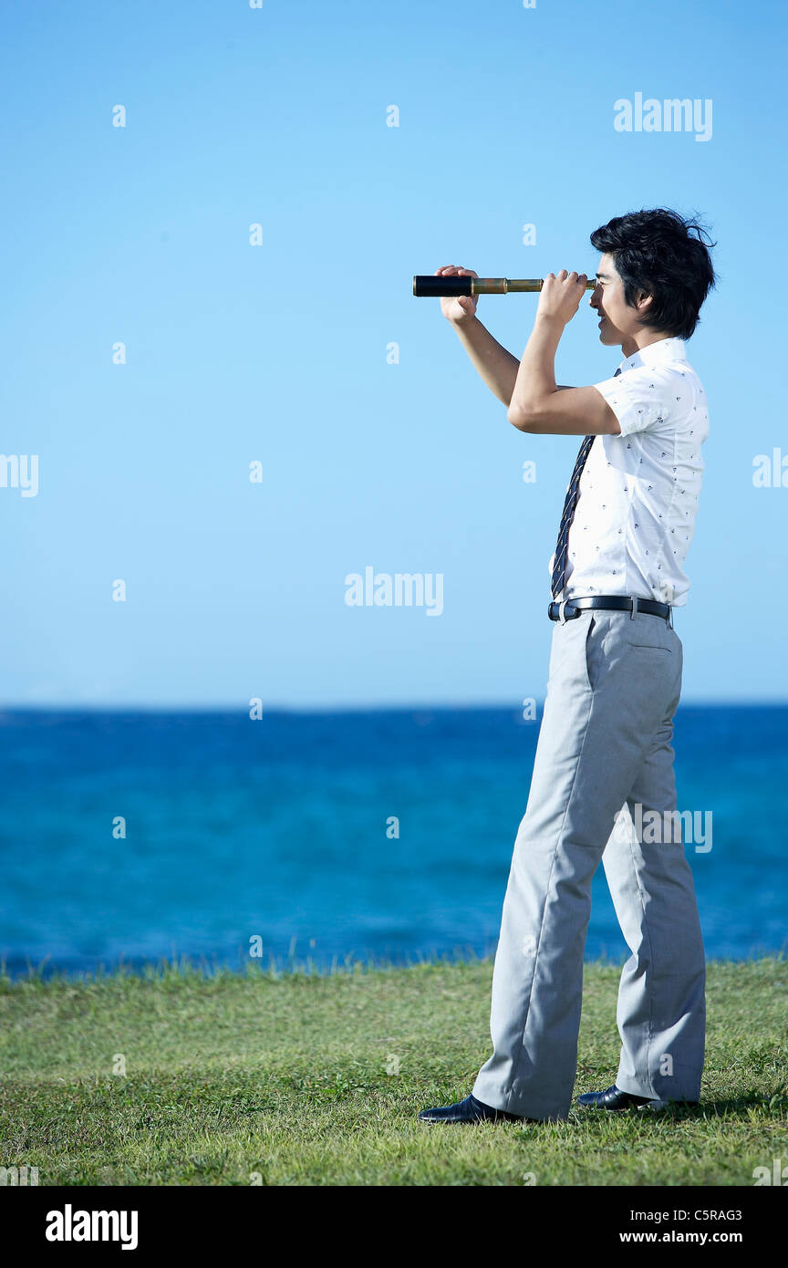 A man looking on telescope Stock Photo - Alamy