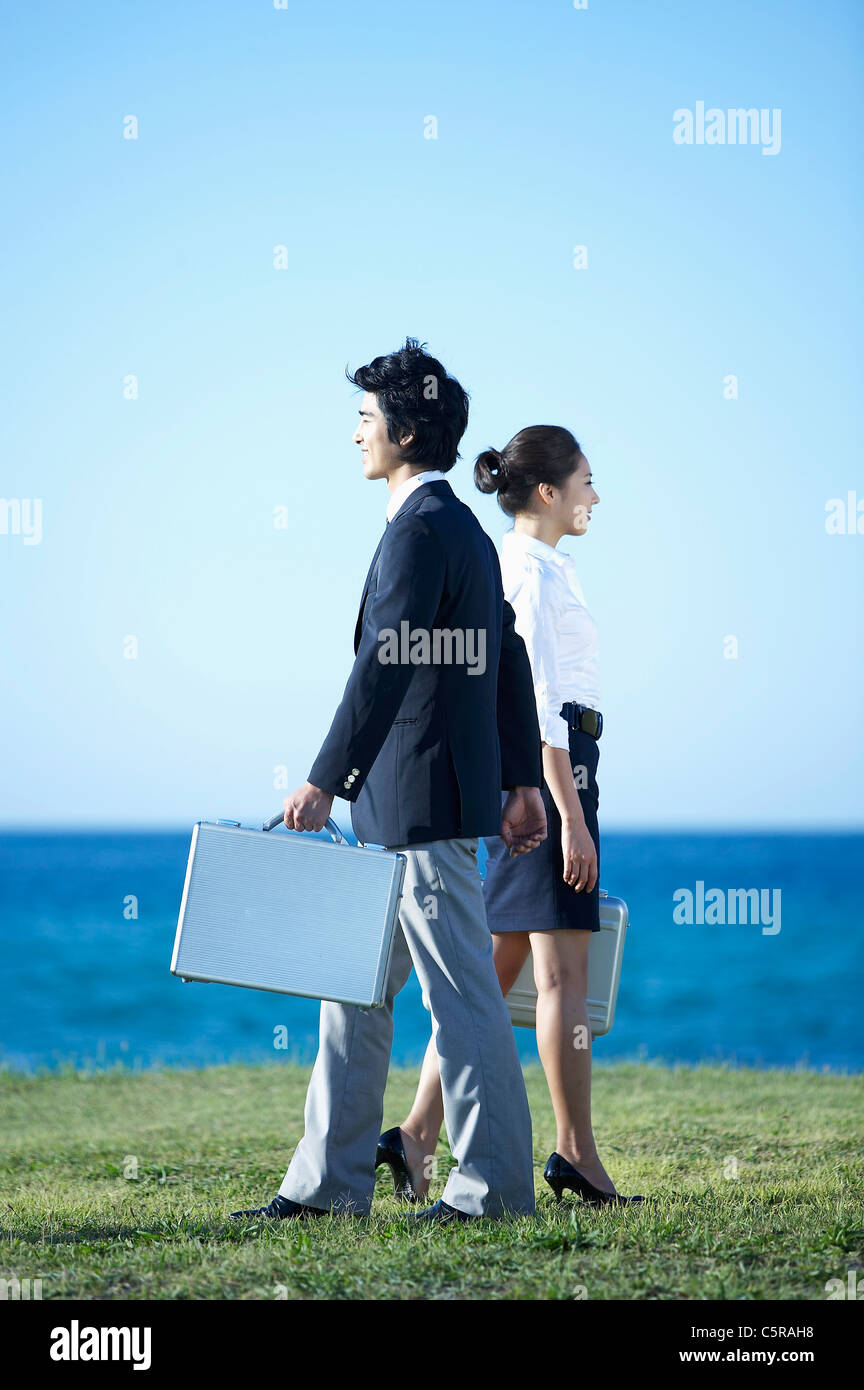 A man and a woman walking toward opposite ways Stock Photo - Alamy