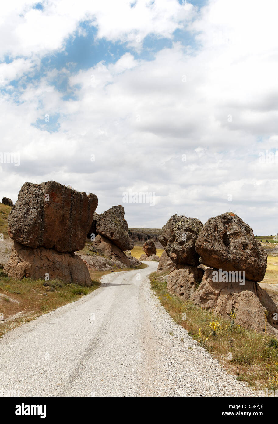 precarious balanced volcanic rocks either side public dirt track ...
