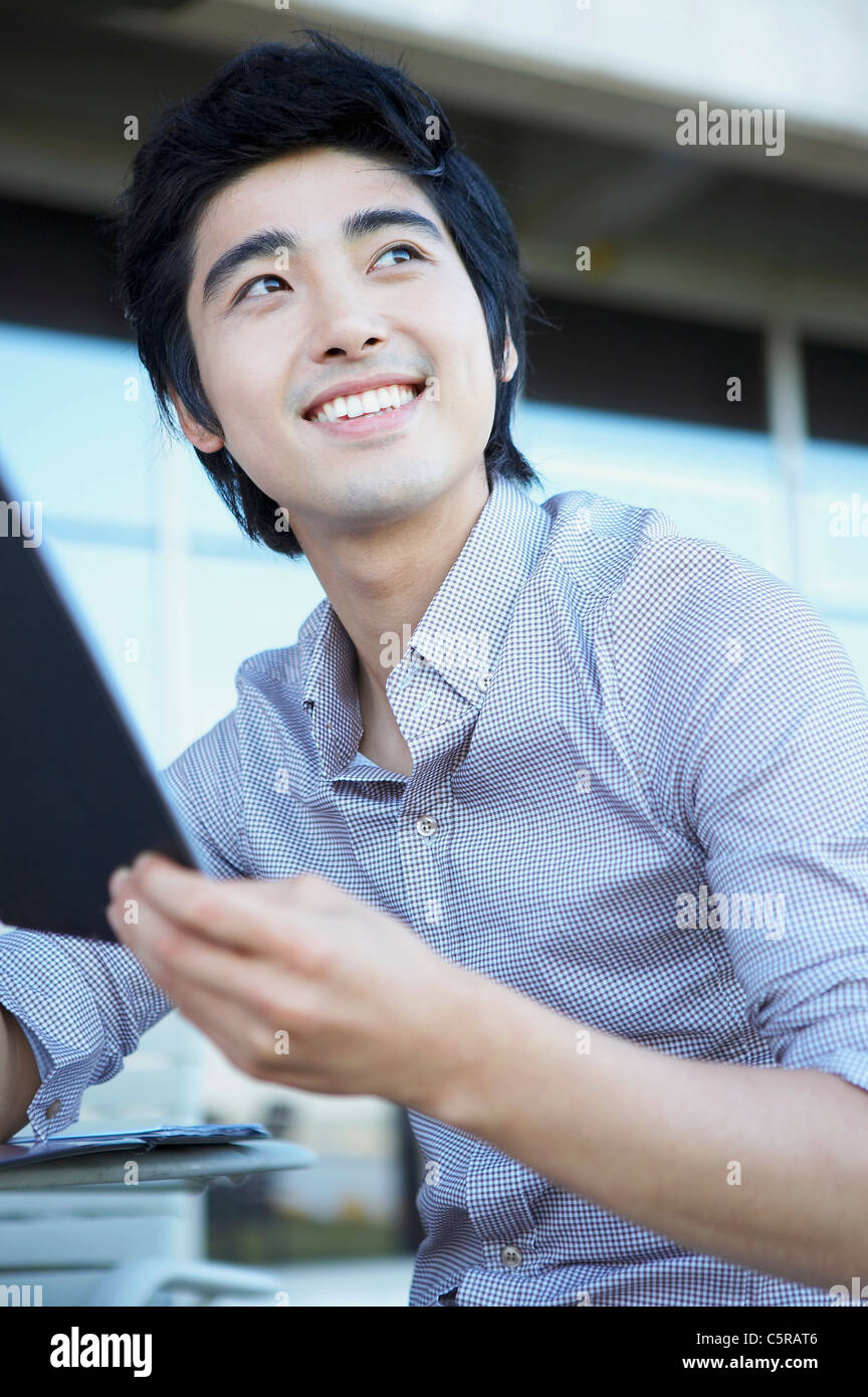 A man holding a notepad Stock Photo - Alamy