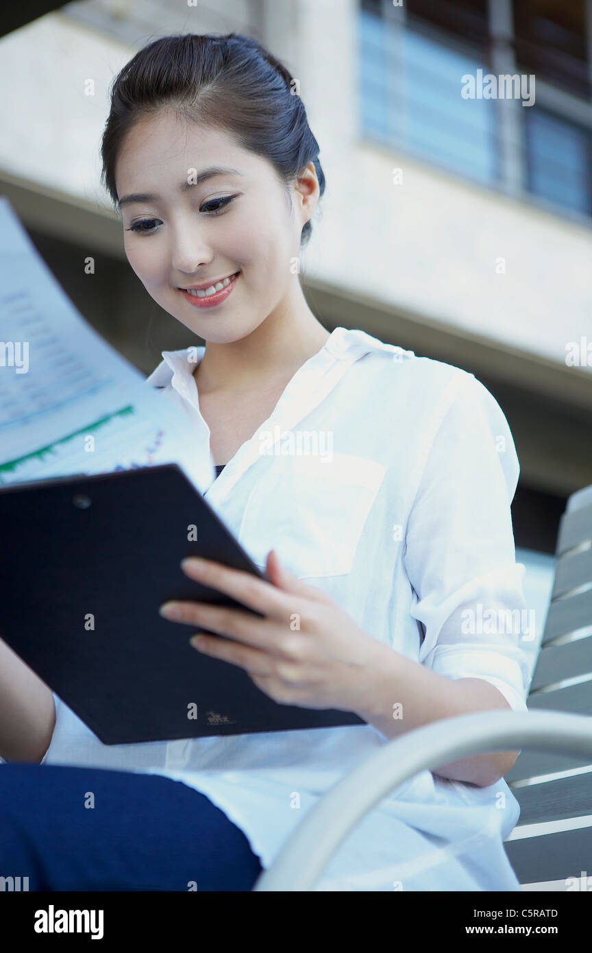 A woman reading documents Stock Photo - Alamy