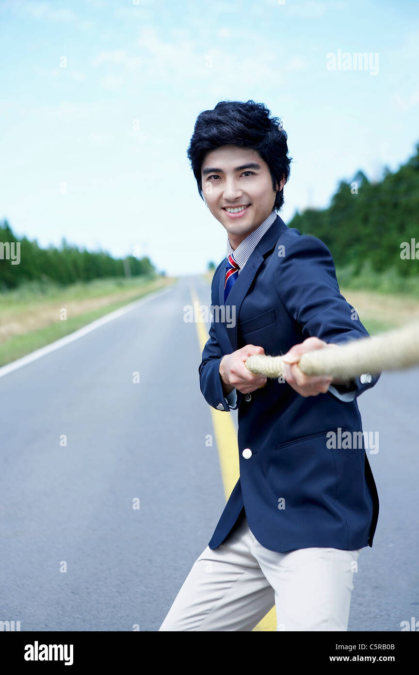 Man pulling on rope hi-res stock photography and images - Alamy