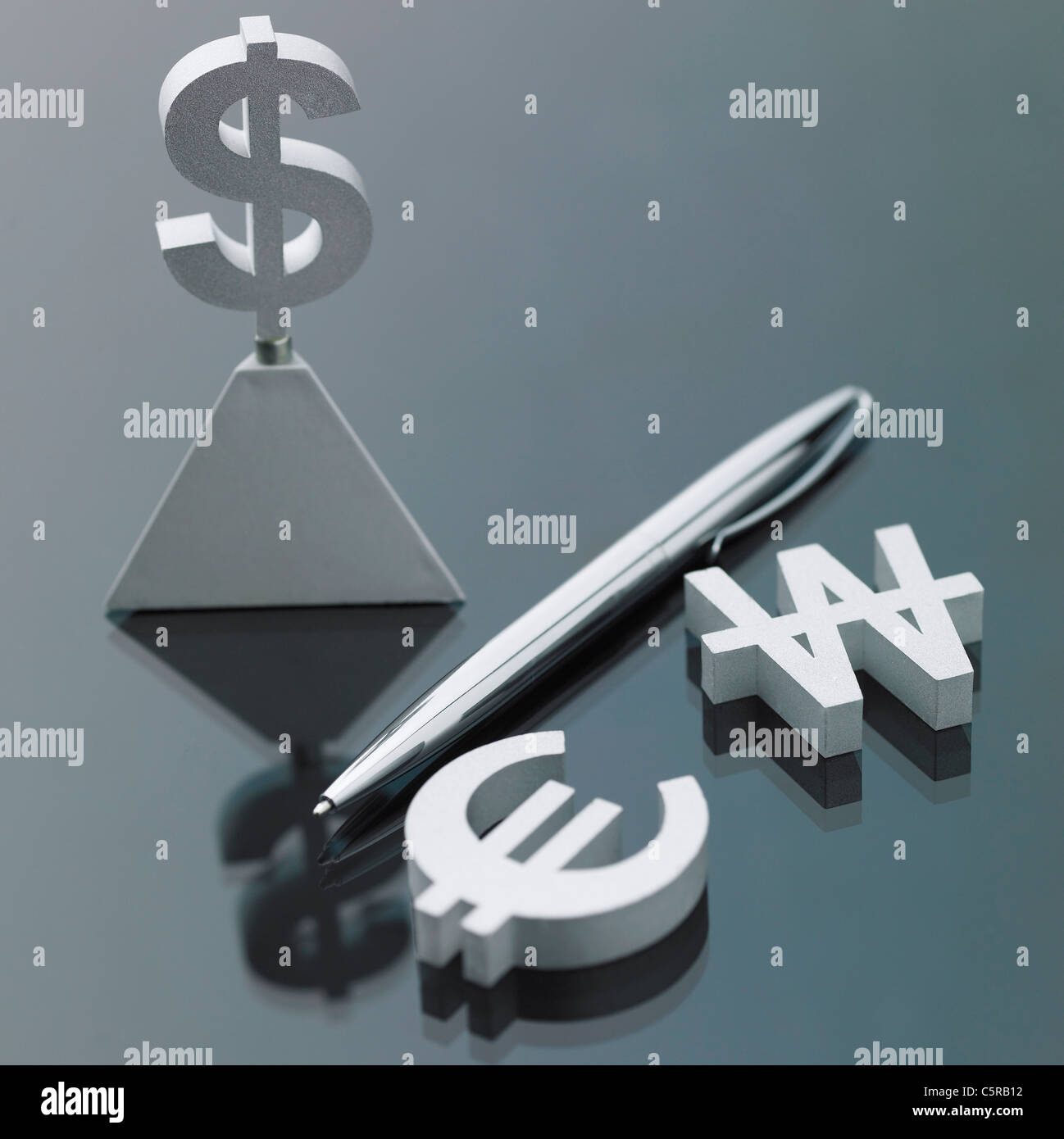 Currency signs and a pen Stock Photo - Alamy