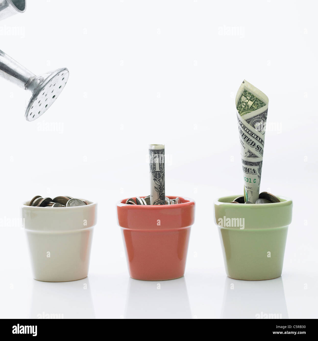 Money inside the flower pots Stock Photo - Alamy