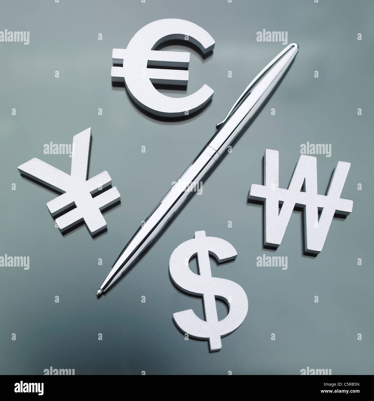 Currency signs and a pen Stock Photo - Alamy