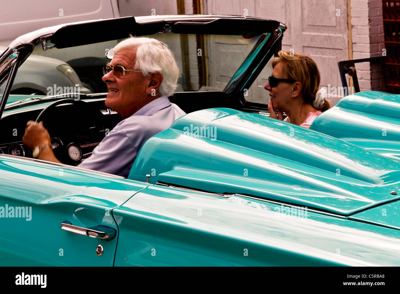 A 1965 pale blue Ford Thunderbird convertible with a mature couple ... A 1965 pale blue Ford Thunderbird convertible with a mature couple ...