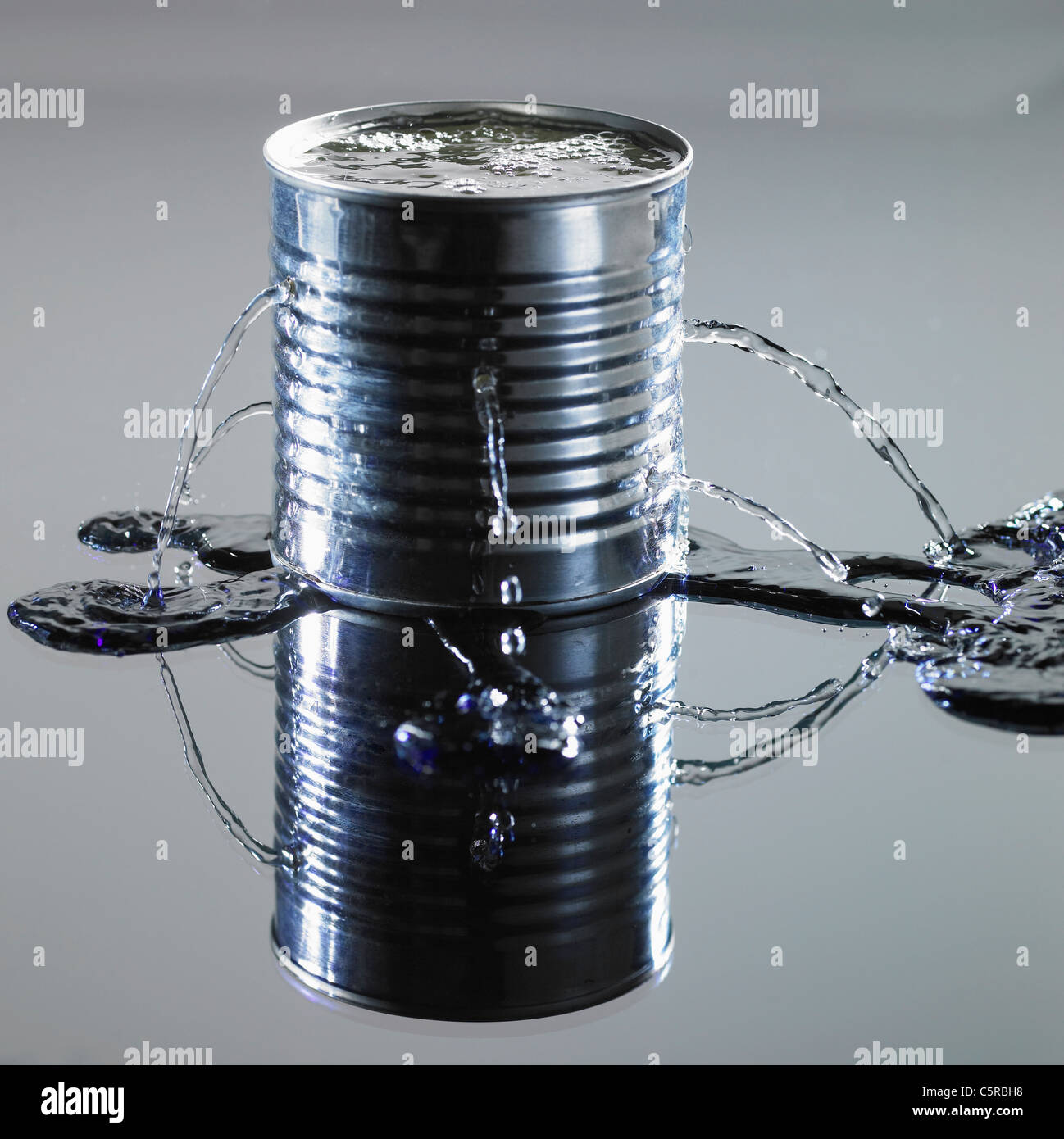 Water leaking from a can Stock Photo - Alamy