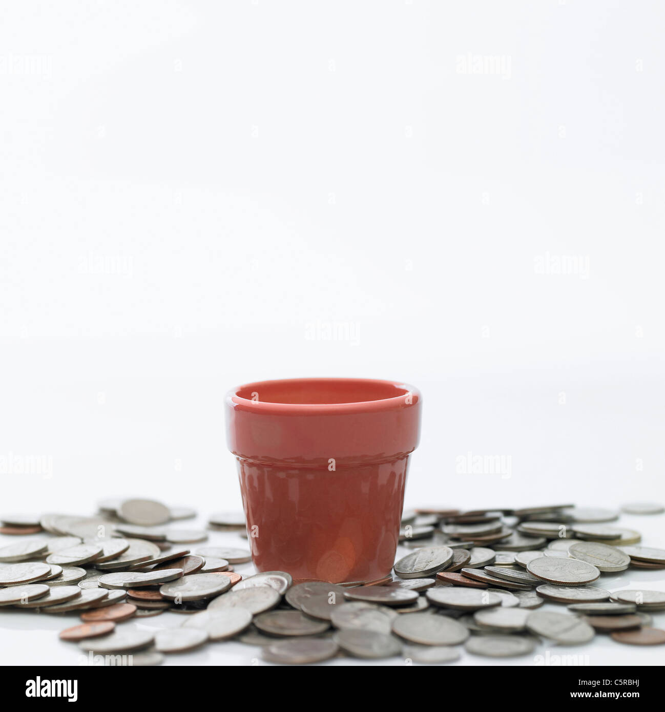A flower pot and coins Stock Photo - Alamy