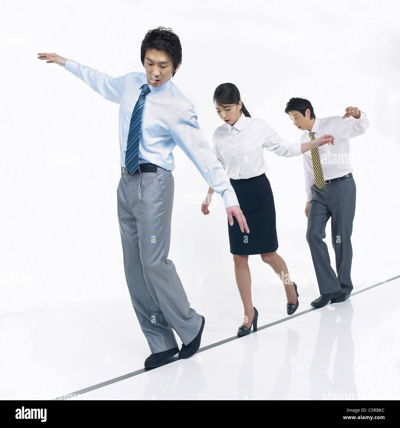 Three people walking on a line Stock Photo - Alamy