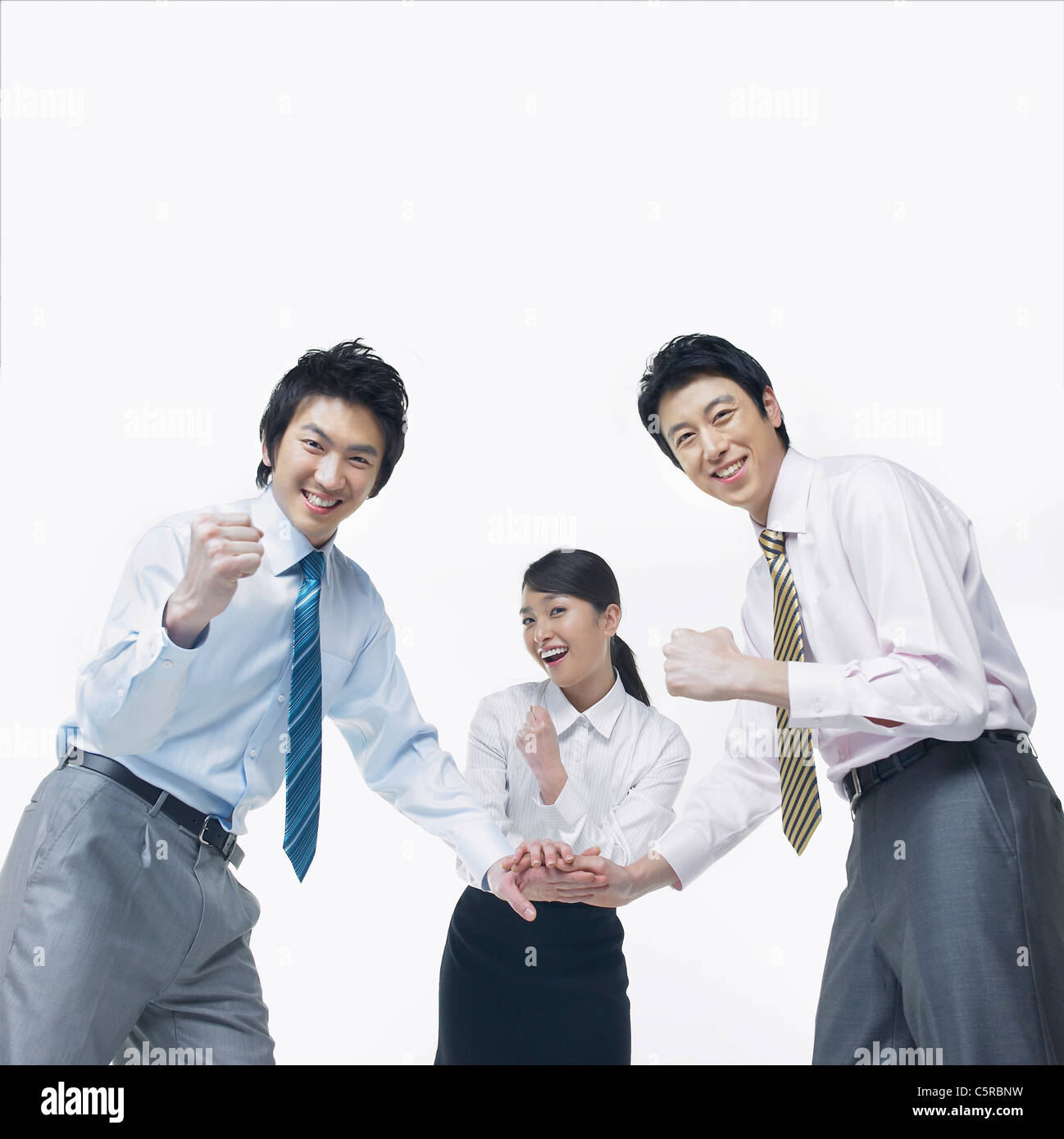 Three people gathering their hands Stock Photo - Alamy
