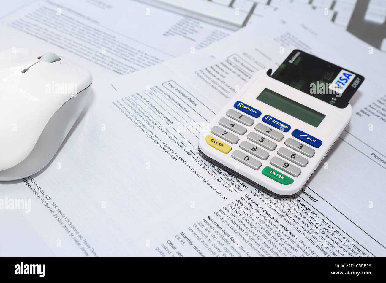 Internet Bank Card Reader with Card Inserted Sitting on Bank Statements ...