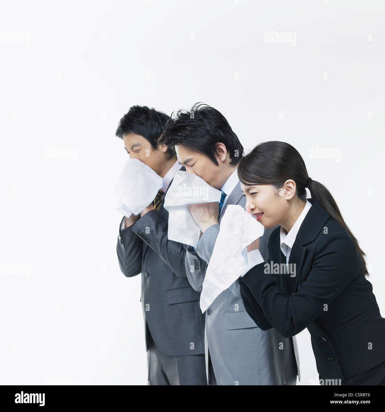 Three people blowing their noses Stock Photo - Alamy