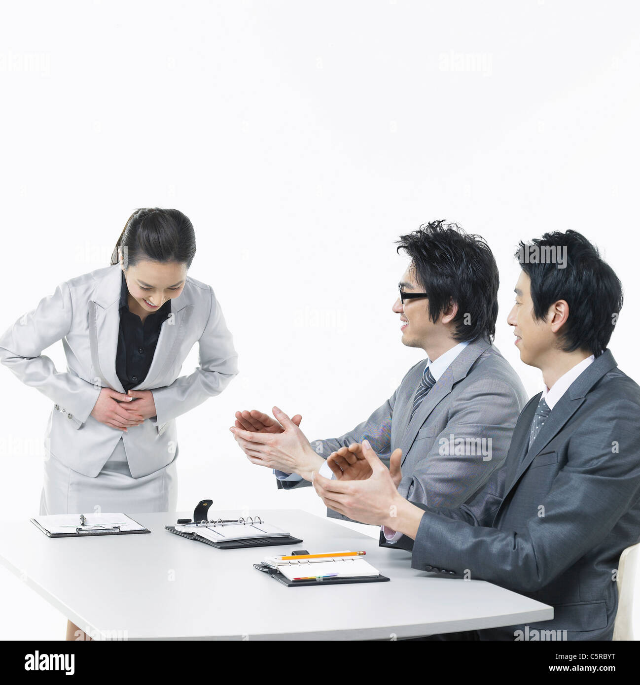 Two man clapping for a woman Stock Photo - Alamy