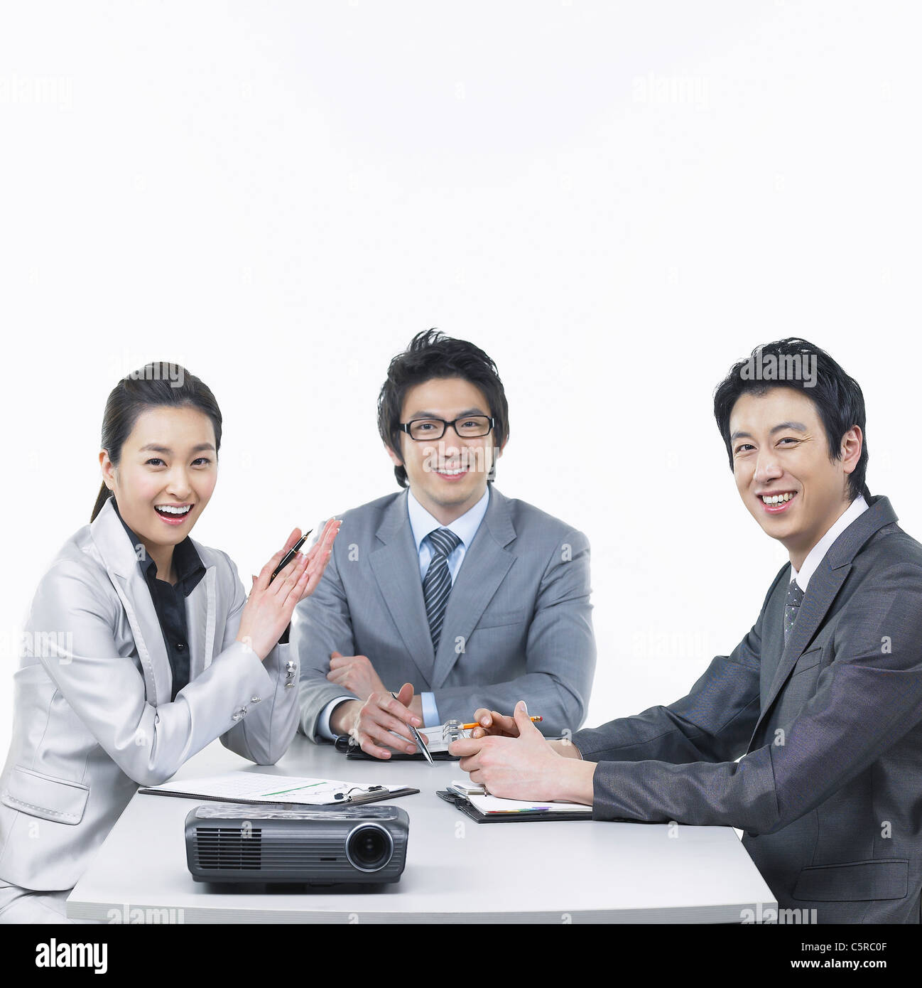Three people smiling sitting on chairs Stock Photo - Alamy