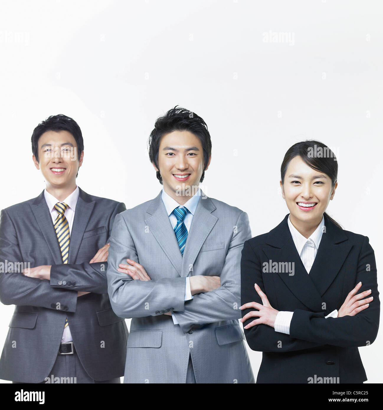 Three people crossing their arms Stock Photo - Alamy