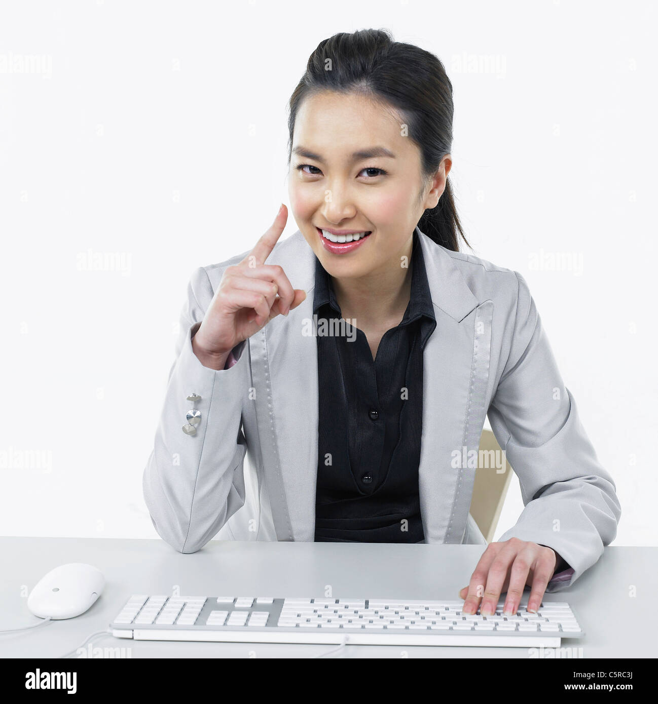 A woman working on a keyboard Stock Photo - Alamy