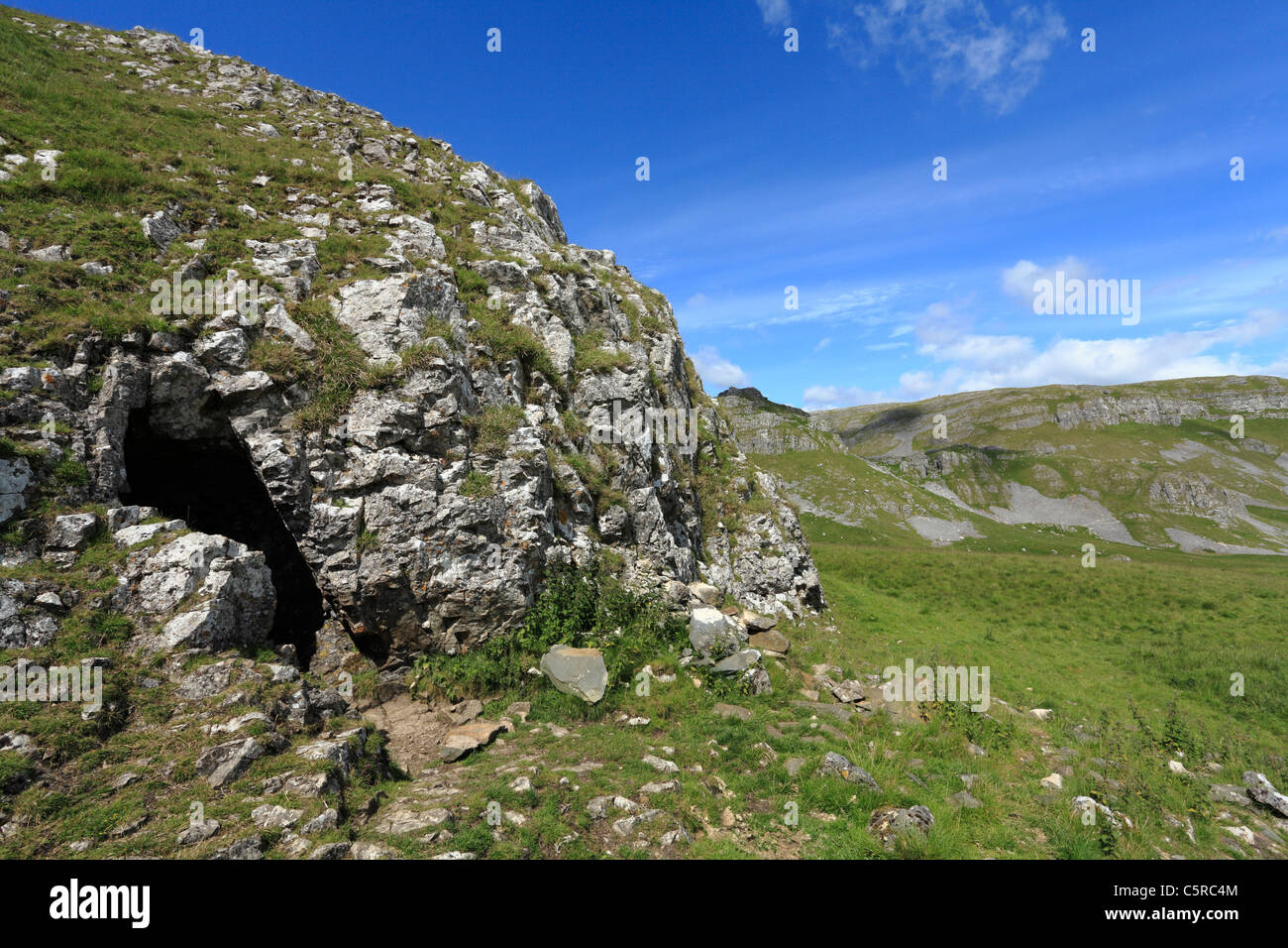 A cave in the Yorkshire dales and the Attermire scar beyond Stock Photo ...
