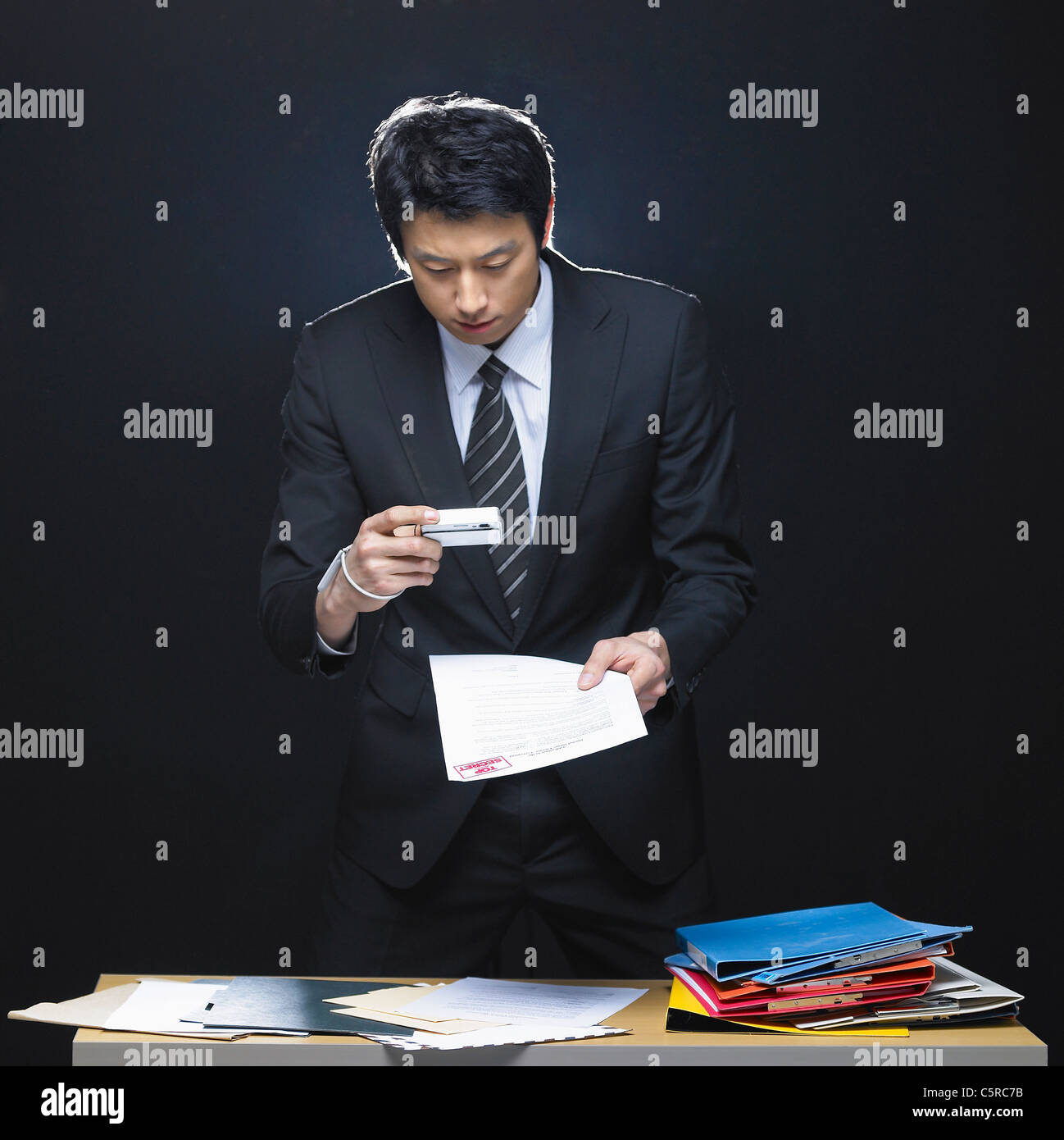 A man illegally sneaking to the classified documents Stock Photo - Alamy