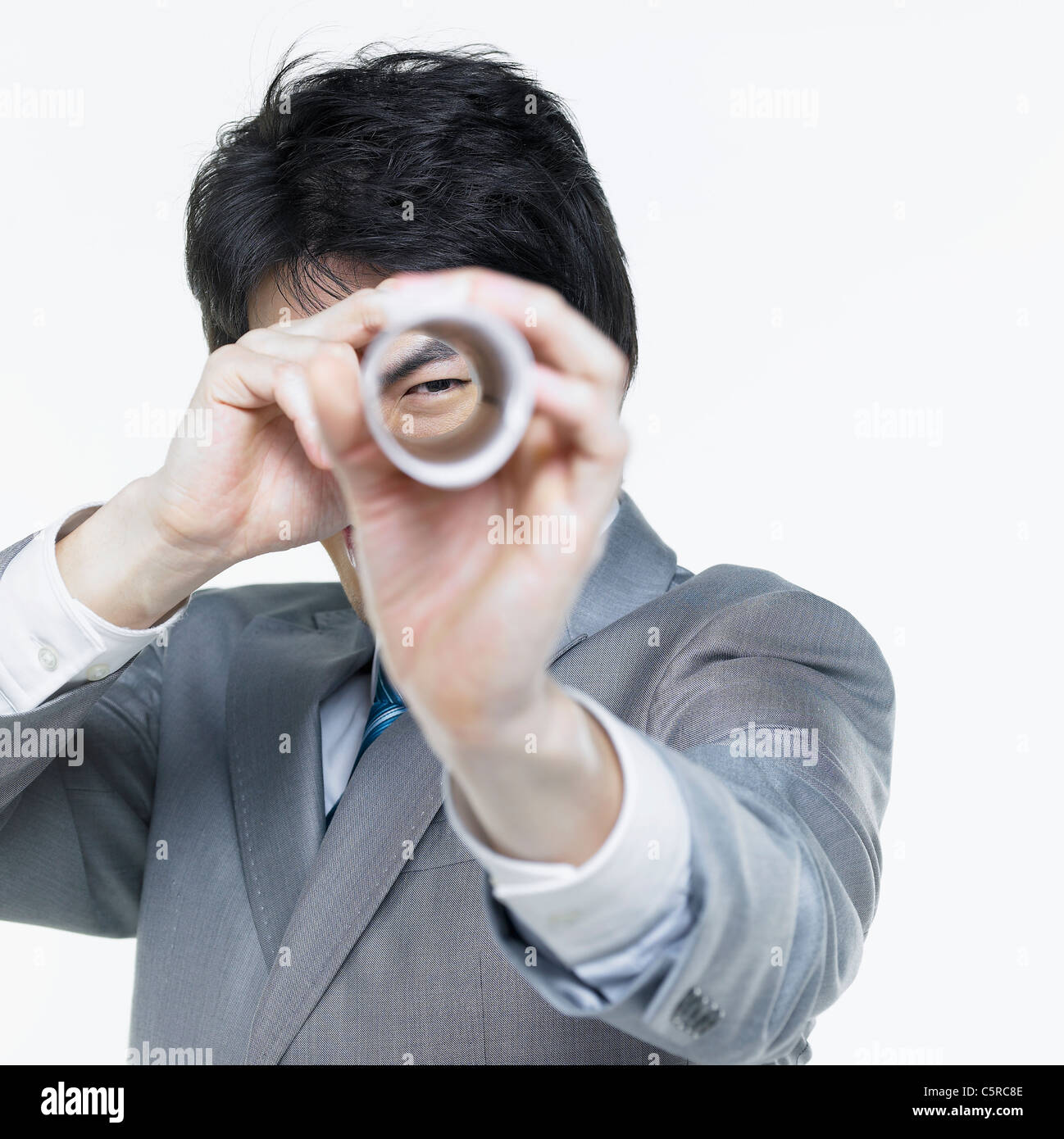 A man looking through a roll Stock Photo - Alamy