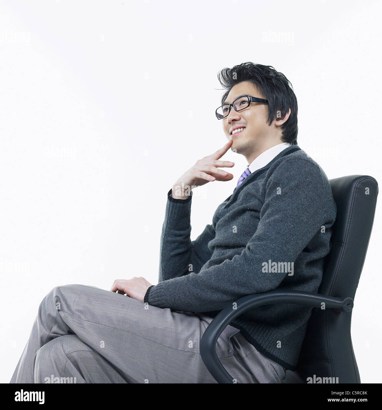 A man sitting on a chair Stock Photo - Alamy