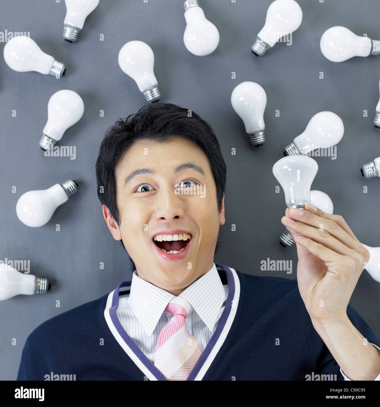 A man holding a light bulb Stock Photo - Alamy