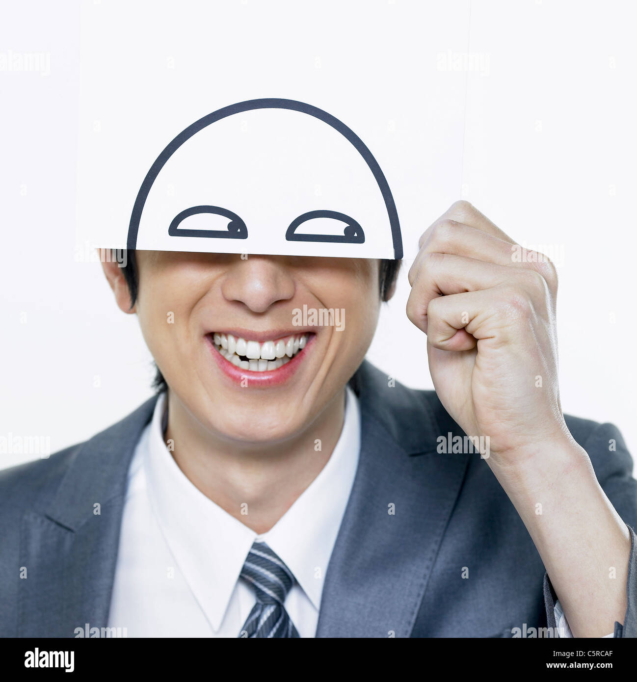 A man putting humorous picture on his face Stock Photo - Alamy