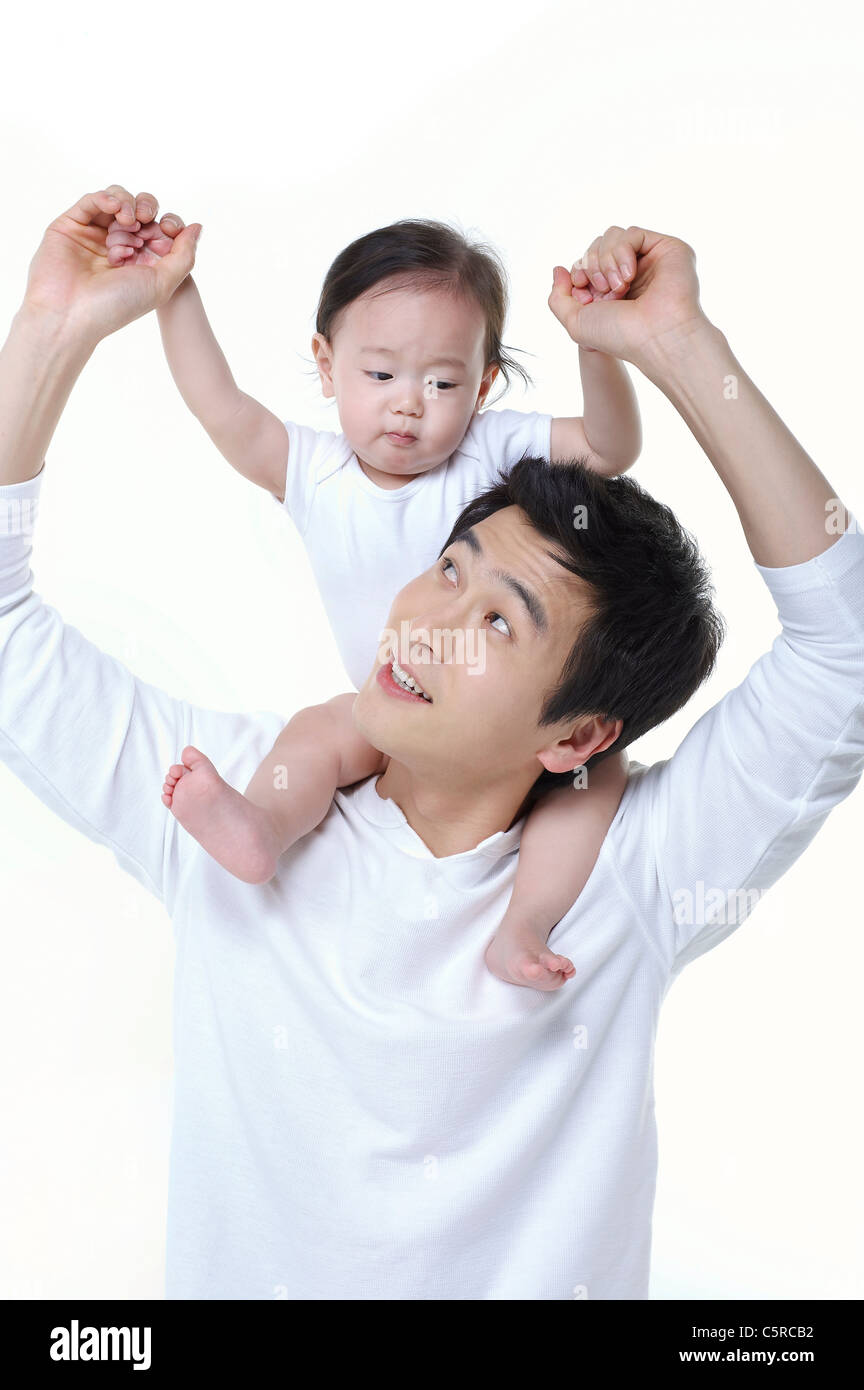 Father giving his baby piggy back Stock Photo - Alamy