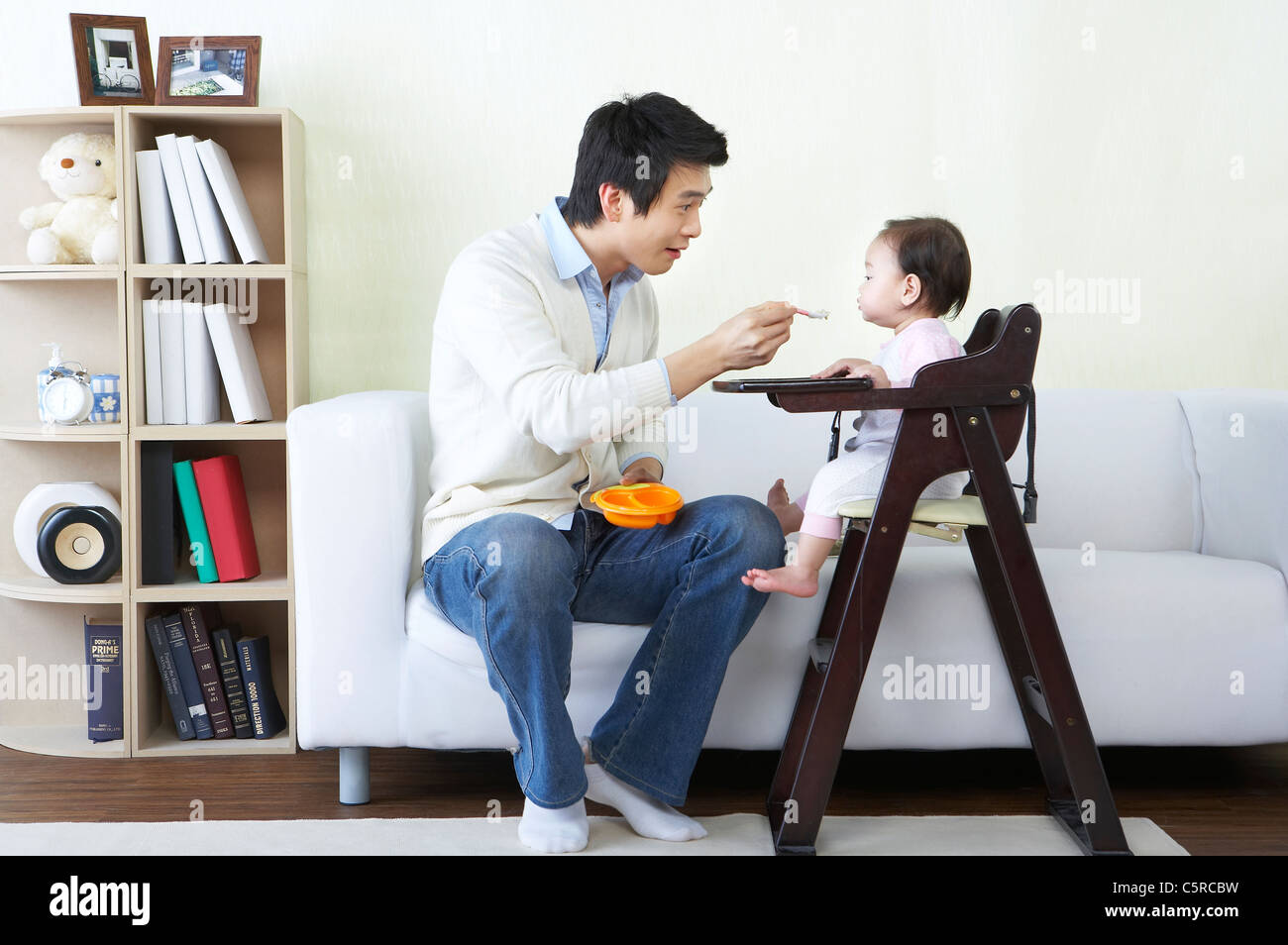A father giving a baby meal Stock Photo - Alamy