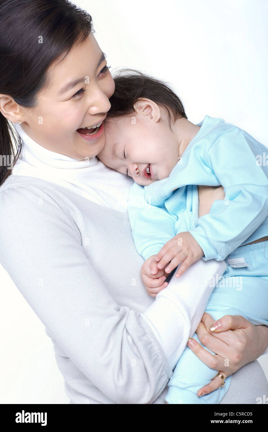 A mother hugging her baby Stock Photo - Alamy