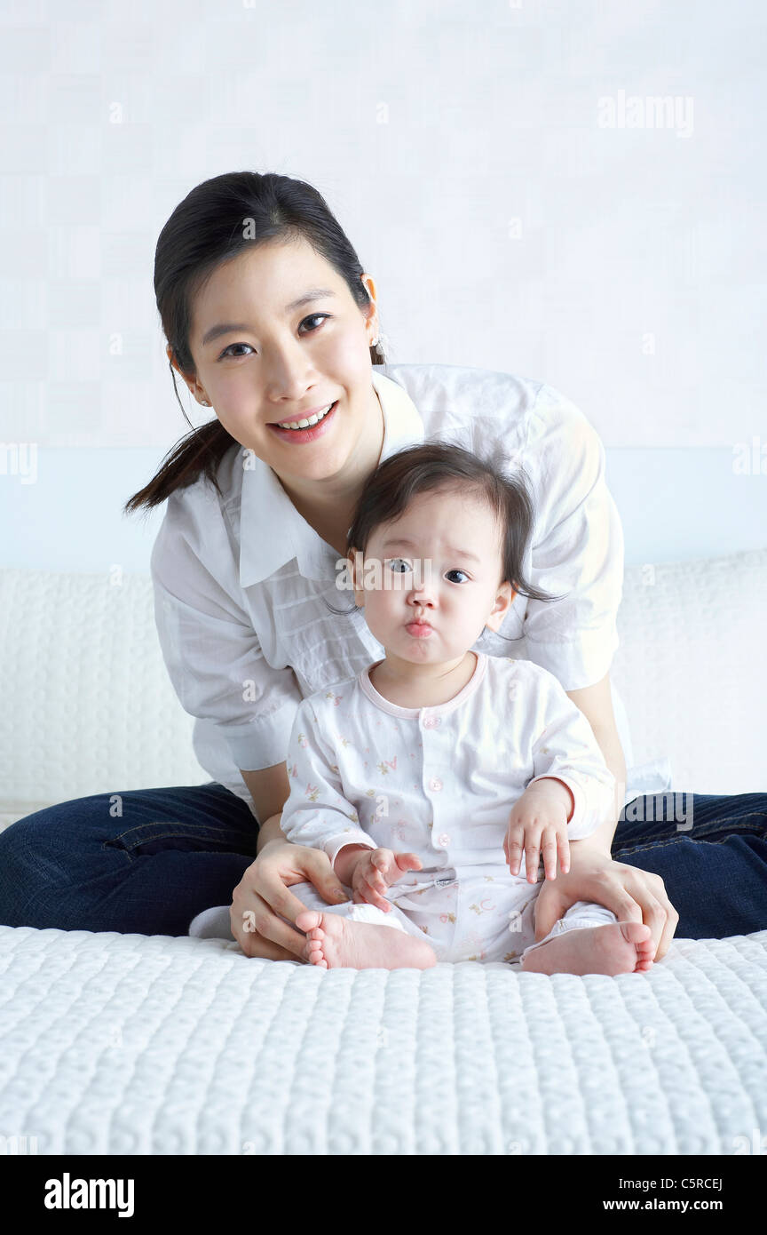 A mother sitting with her baby Stock Photo - Alamy