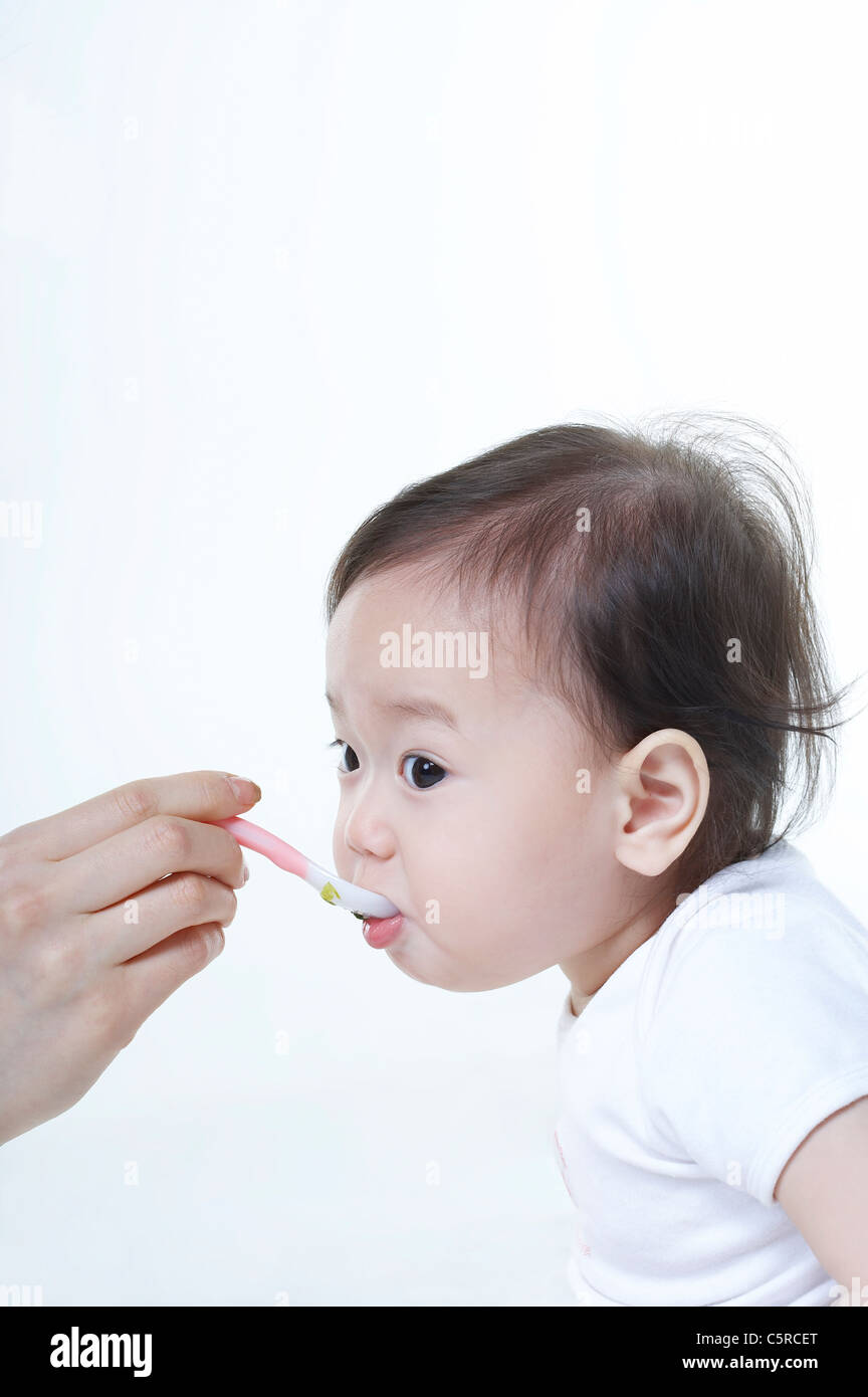 A baby eating food Stock Photo - Alamy