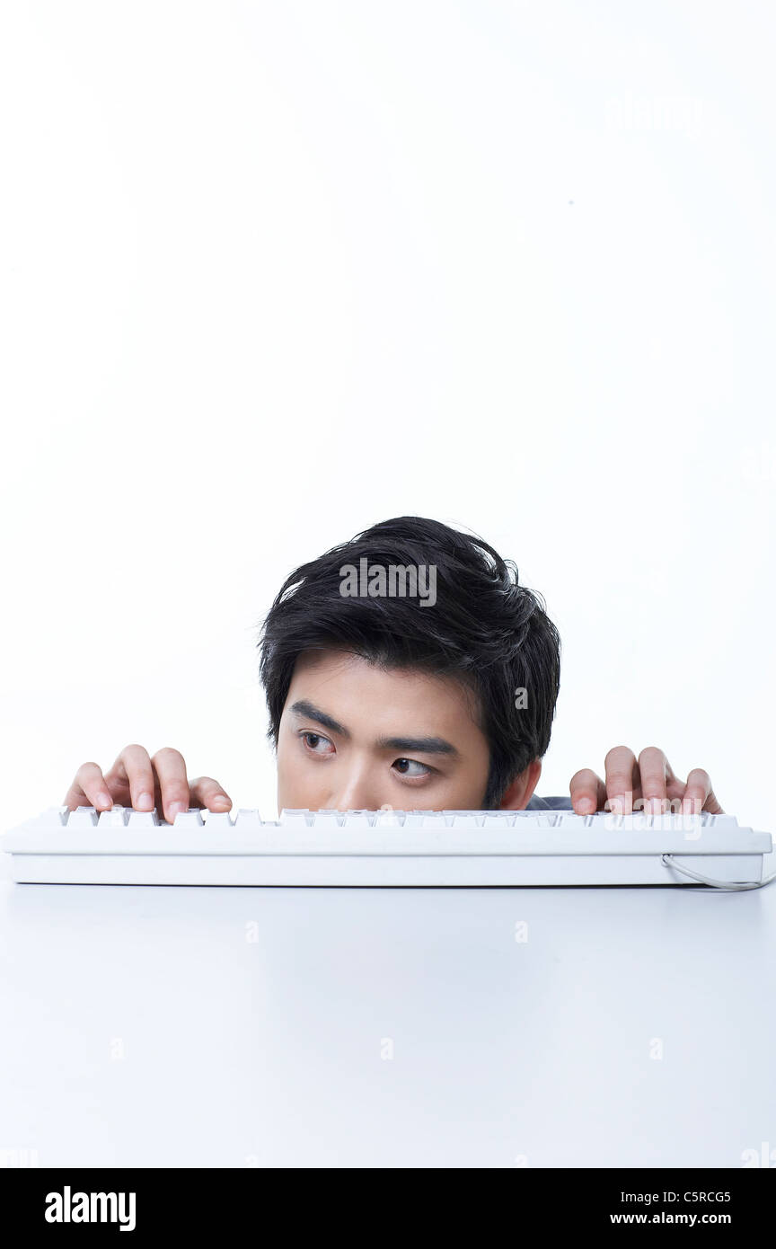 Man hiding behind computer hi-res stock photography and images - Alamy