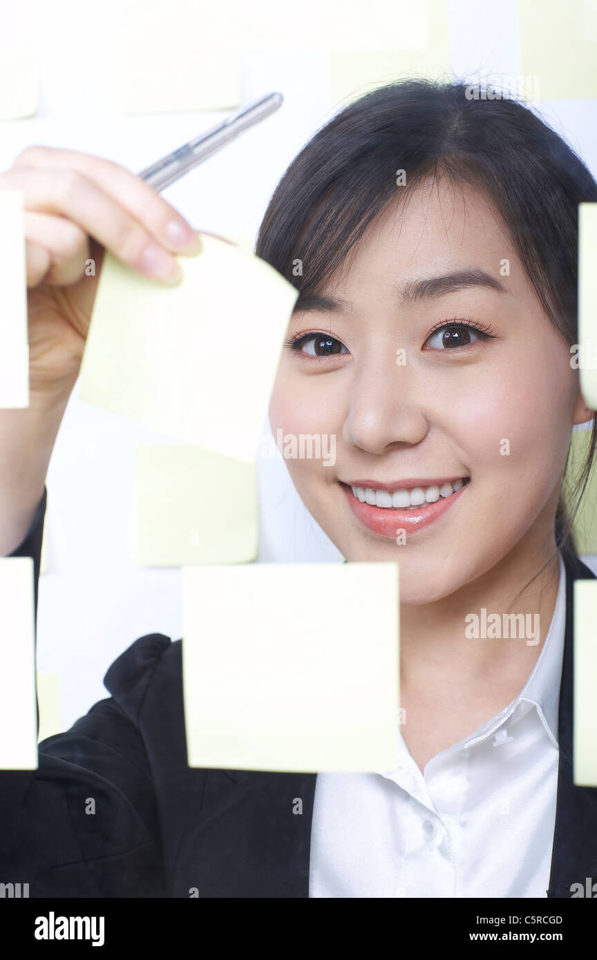 A business woman holding one of the post its Stock Photo - Alamy
