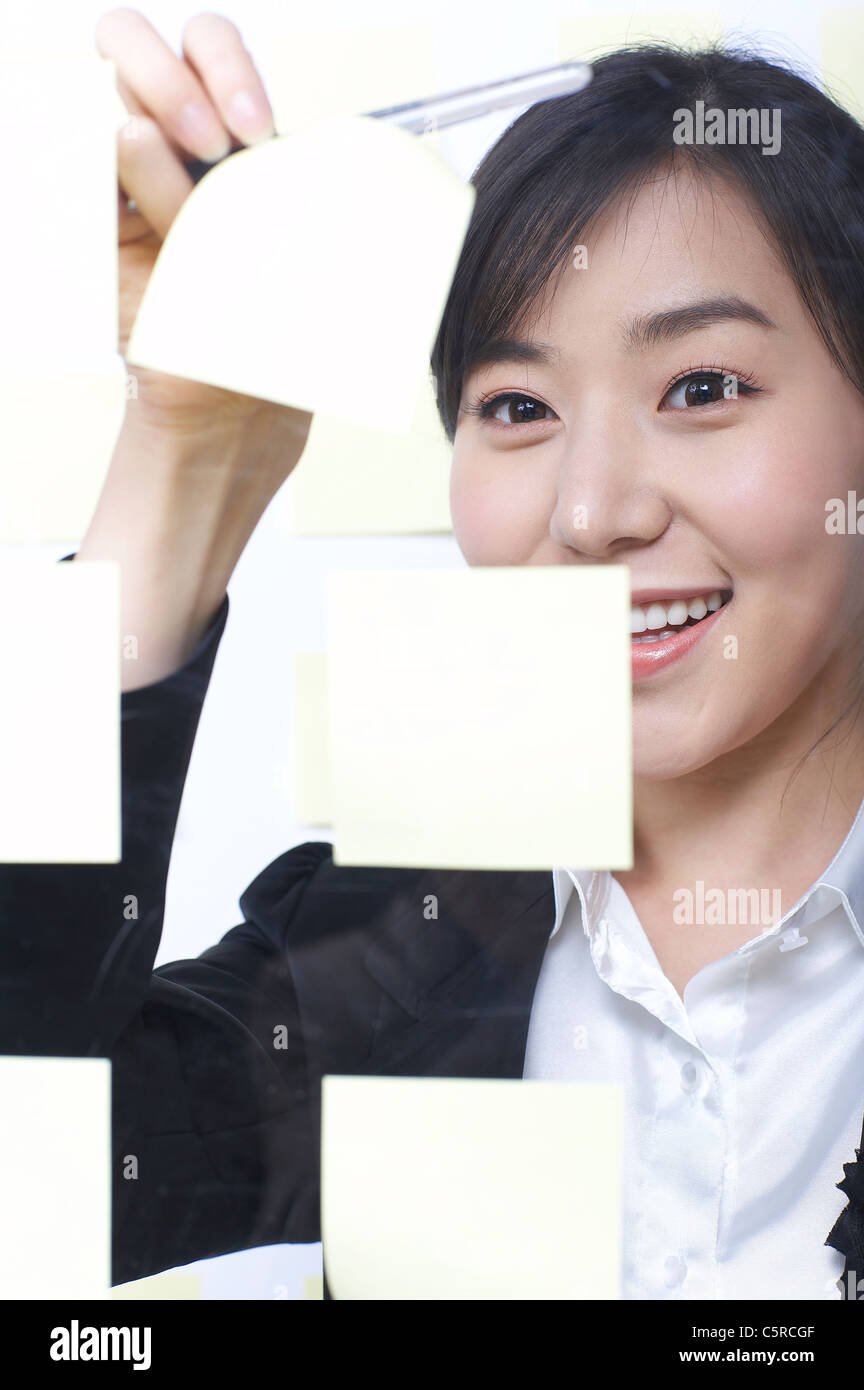 A business woman holding one of the post its Stock Photo - Alamy