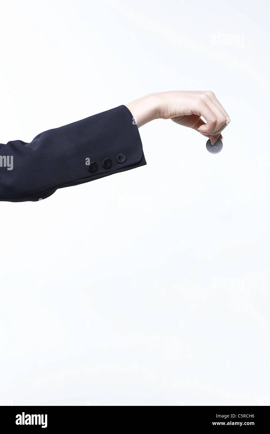 A hand holding a coin Stock Photo - Alamy