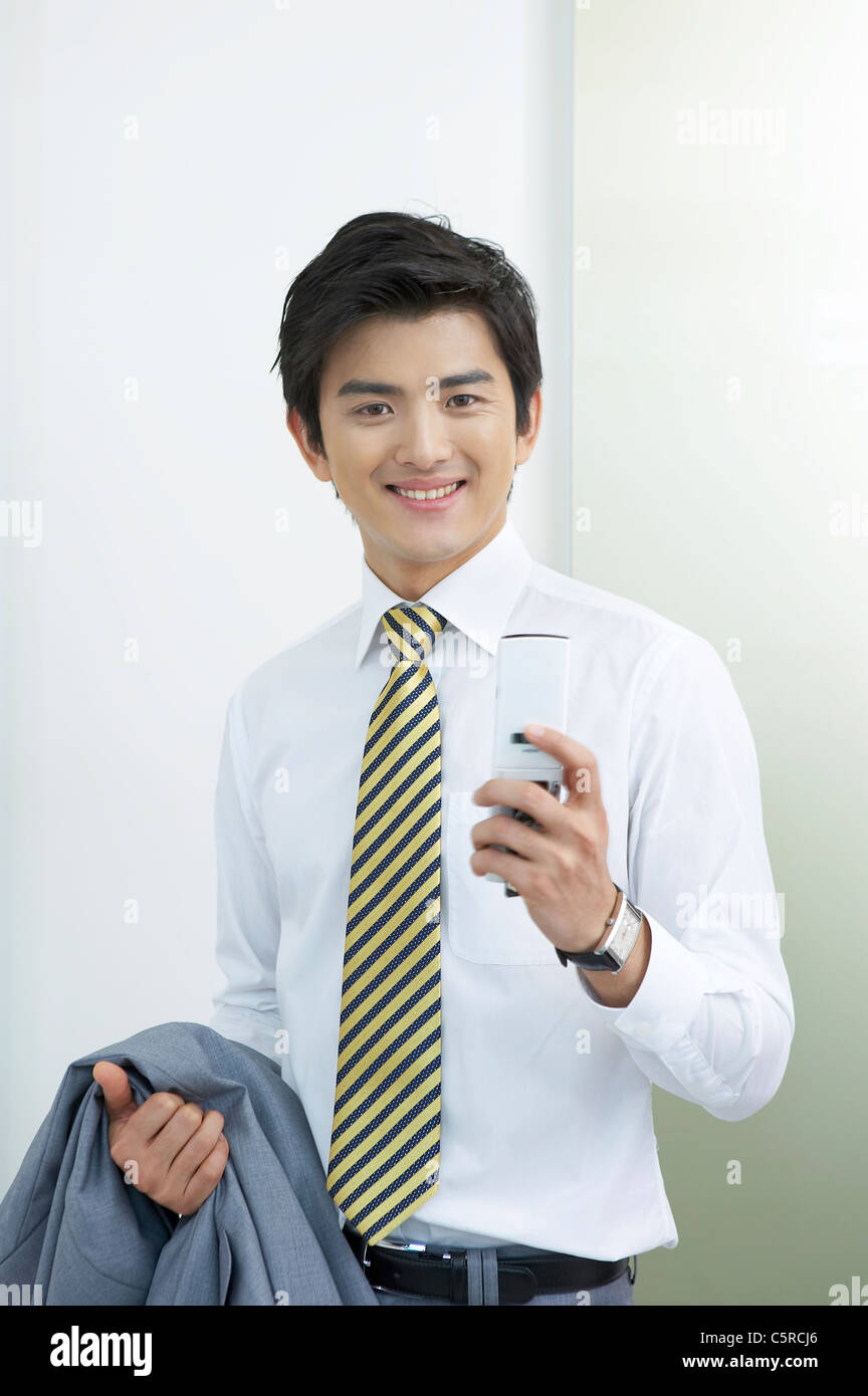A business man holding cell phone Stock Photo - Alamy