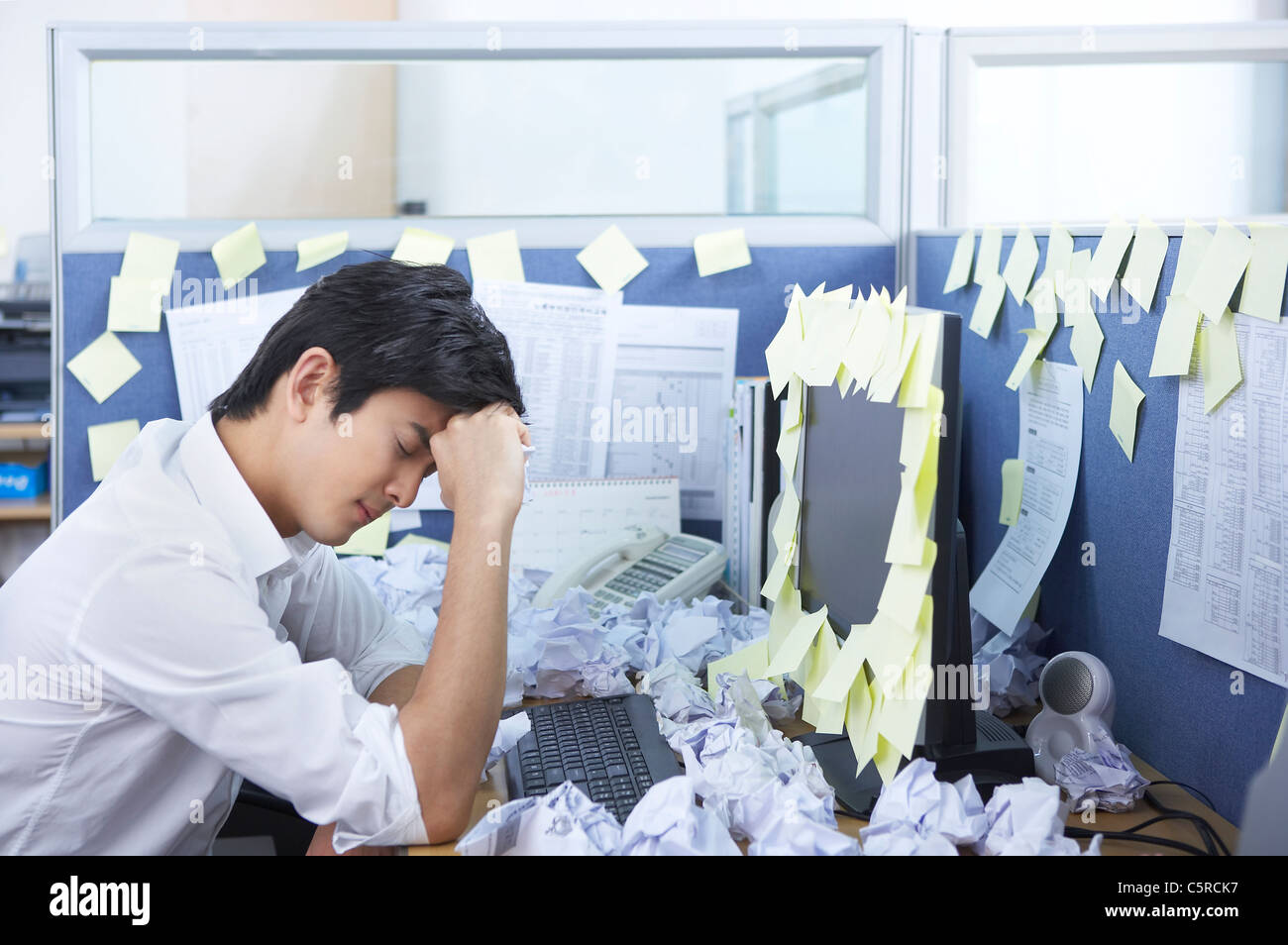 A business man in agony in front of disordered desk Stock Photo - Alamy