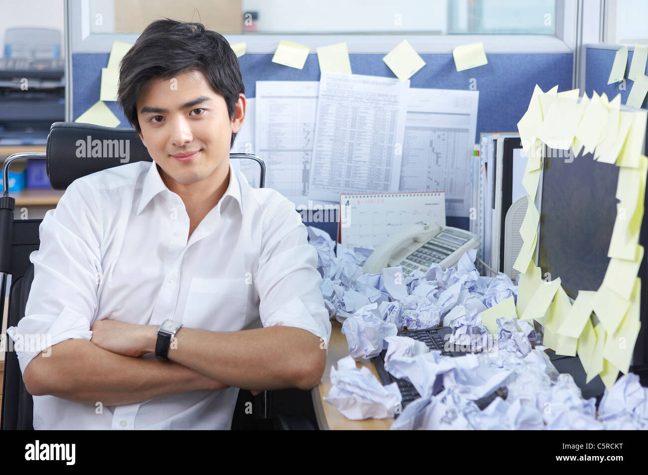 A business man sitting in front of disordered desk Stock Photo - Alamy