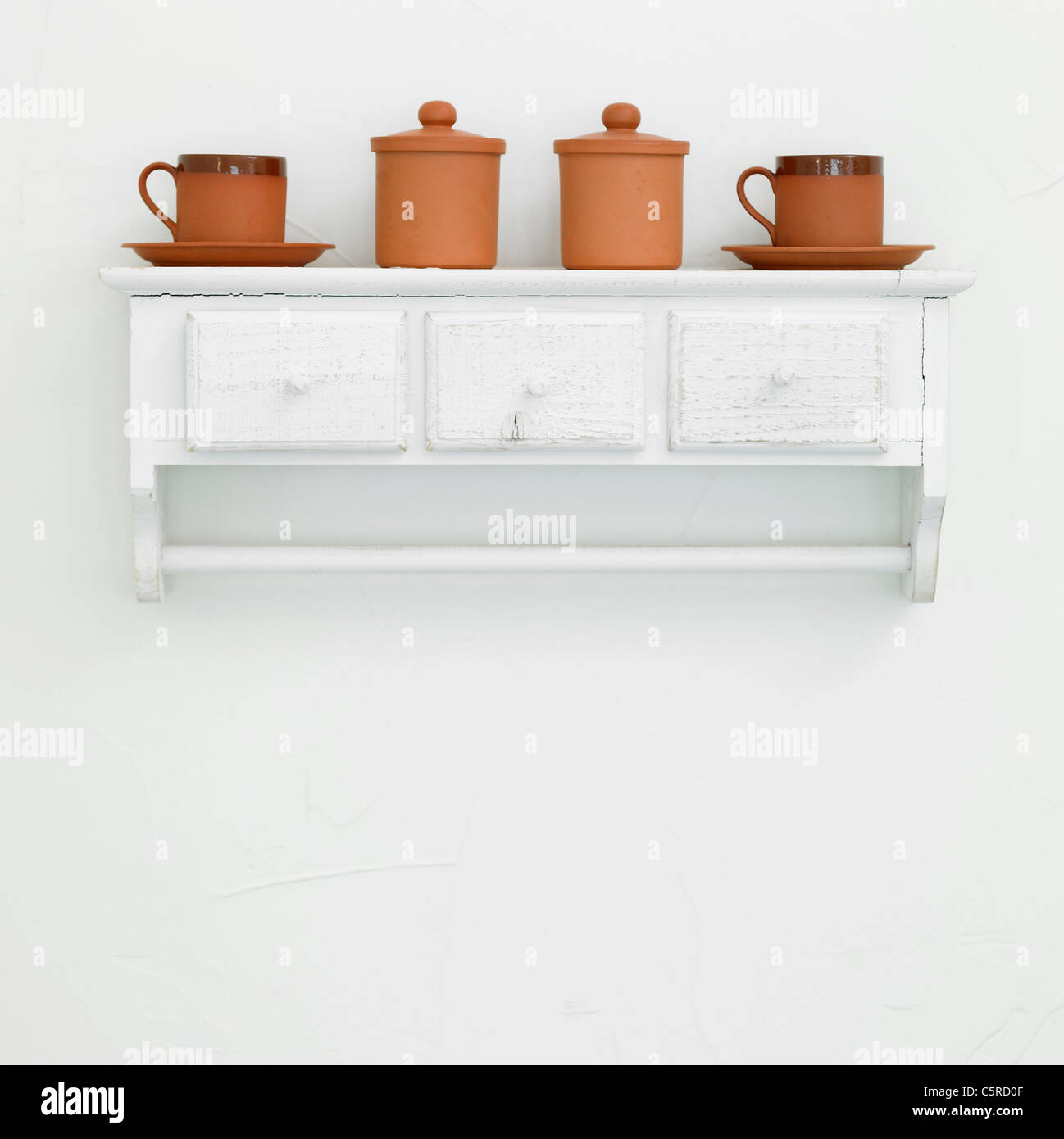 Tea cups and containers over a drawer Stock Photo - Alamy