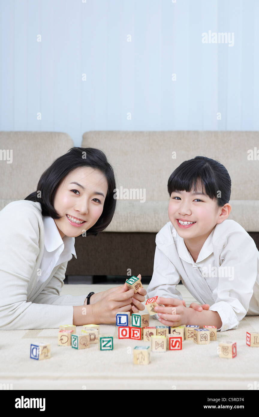 A mother and her daughter playing with blocks Stock Photo - Alamy