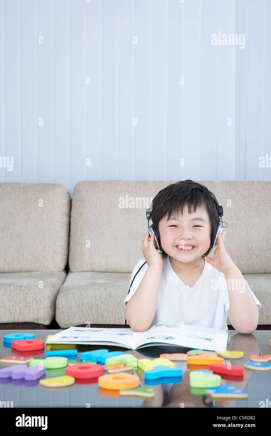 A boy smiling with a headset on Stock Photo - Alamy