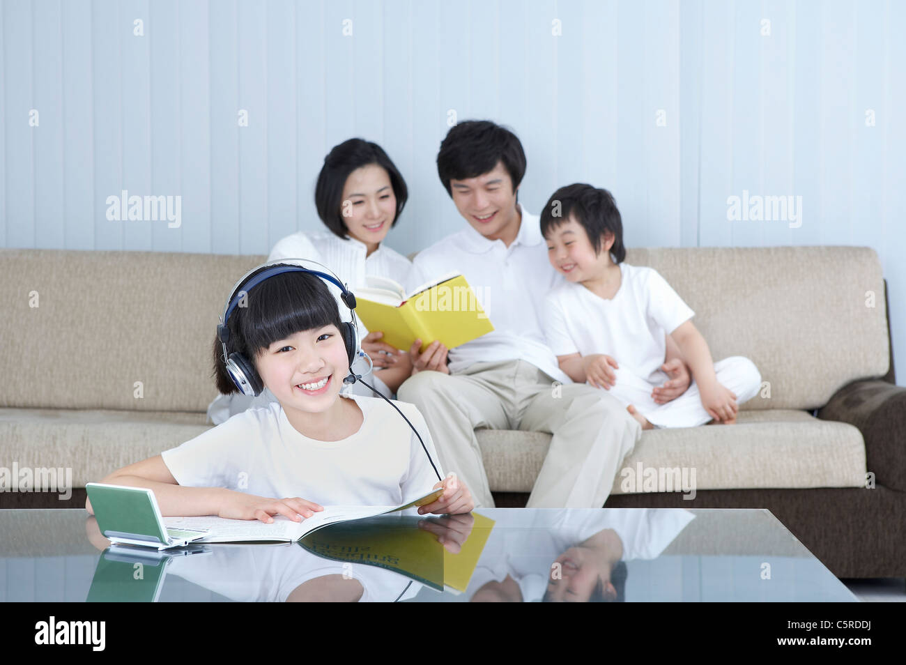 A family studying in a living room Stock Photo - Alamy