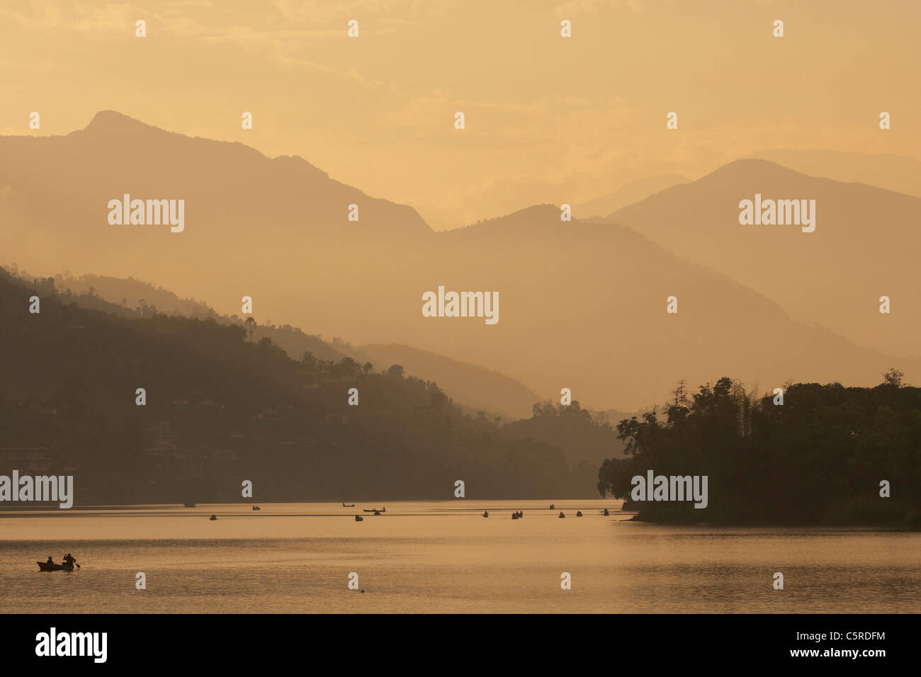 Wooden boats on lake Phewa (Fewa) Tal at sunset, Pokhara, Nepal, Asia ...