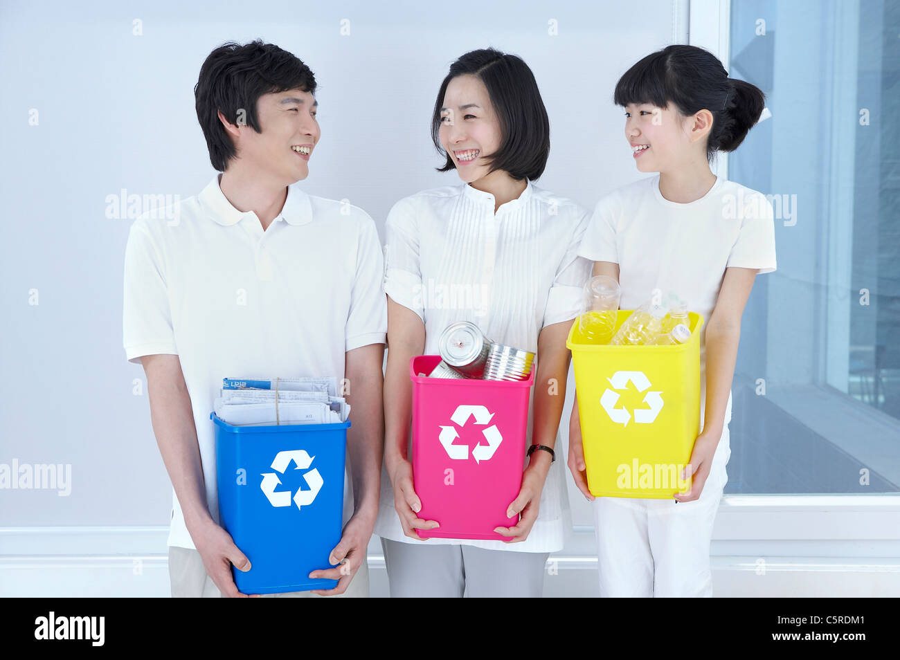 A family holding recycle bins Stock Photo - Alamy